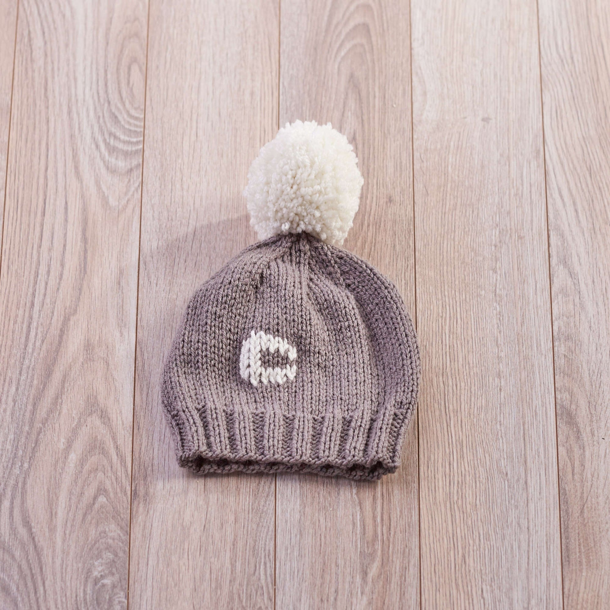 Free Easy Red Heart Monogram Pom Pom Hats Knitting Pattern | Yarnspirations